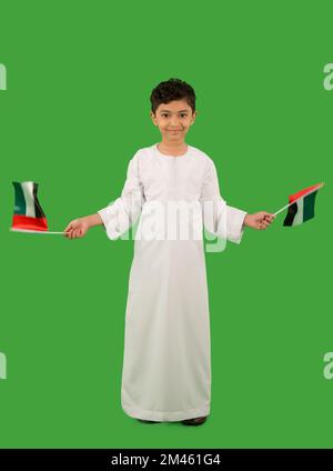 Portrait of an Arab boy holding a UAE national flag Stock Photo - Alamy