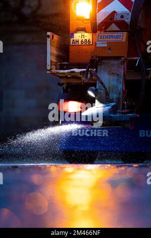 Hanover, Germany. 19th Dec, 2022. A gritting vehicle spreads grit on ...