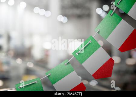 A garland of Italy national flags on an abstract blurred background ...