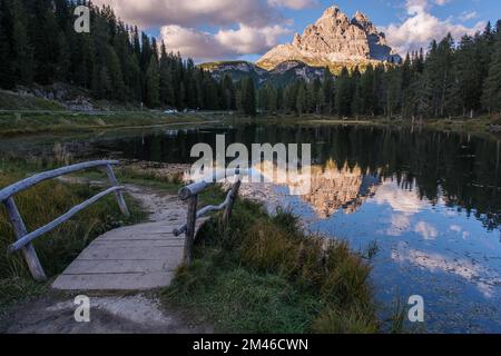 Fantastic panoramic view of the Antorno lake with blue sky at sunset in ...