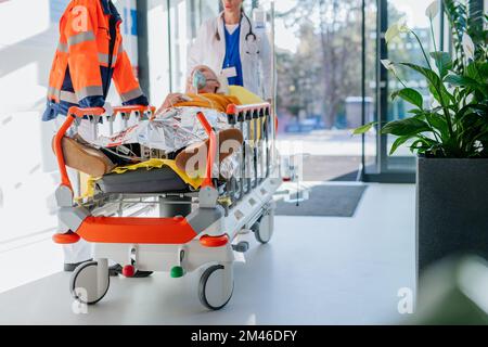 Rescuers bringing patient with serious injury to hospital Stock Photo ...