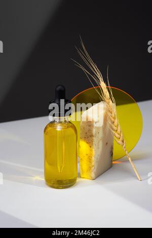 Creative concept photo of cosmetic bottle with splashing liquids made ...