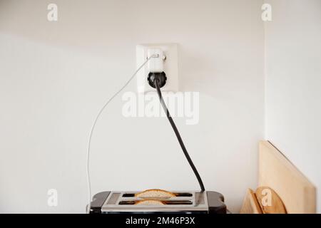 Toaster plugged into an outlet Stock Photo - Alamy
