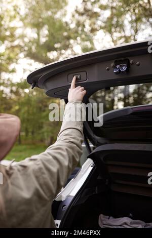 Hand closing car trunk Stock Photo - Alamy