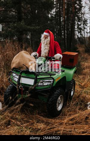 Man wearing Santa costume riding lawn mower Stock Photo - Alamy