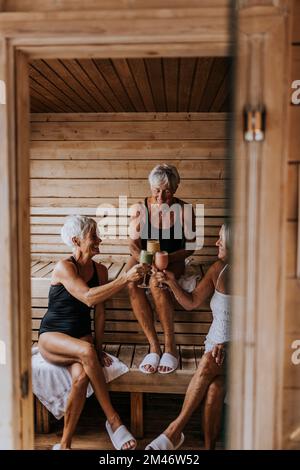Happy female friends in sauna Stock Photo - Alamy