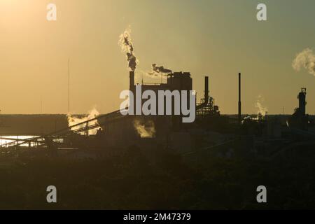 Huge factory with high chimneys polluting atmosphere with carbon ...