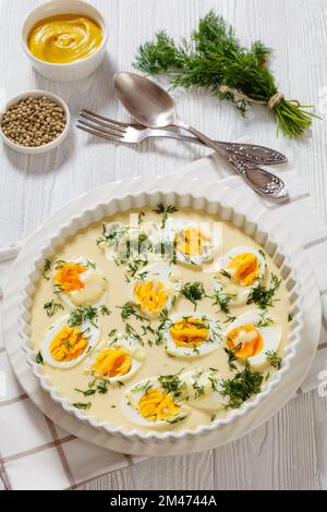 Senfeier, hard boiled eggs in rich creamy mustard sauce in white baking ...
