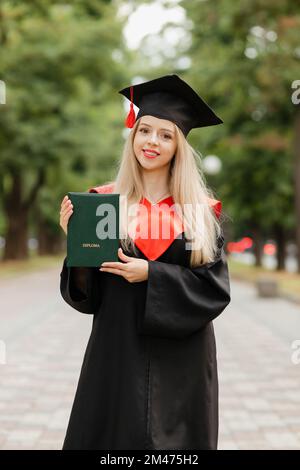 Diploma with a red ribbon in hand isolated on white Stock Photo - Alamy