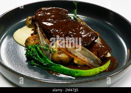 Slow cooked pulled rib beef burger with melted cheese and sides Stock ...
