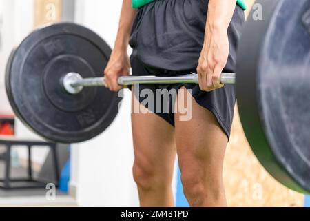 Unrecognizable young man lifting dead weight in the gym Stock Photo - Alamy