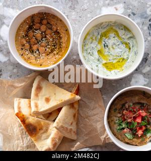 Pita with hummus over light background. Top view, flat lay. Food for ...