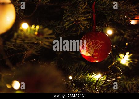 Christmas bauble in vintage drinking glass and golden ribbon on white ...