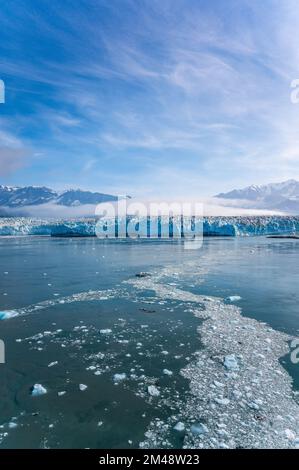 A big frozen lake with glaciers and mountains in the background on a ...