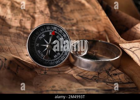 Small compasses on world map Stock Photo - Alamy