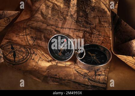 Small compasses on world map Stock Photo - Alamy