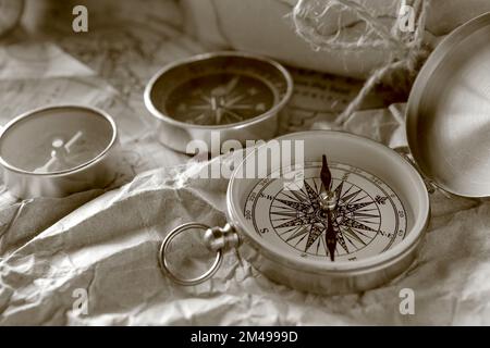 Different vintage compasses on world map Stock Photo - Alamy