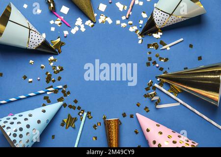 Party hats, confetti, straws and whistle on blue background Stock Photo ...