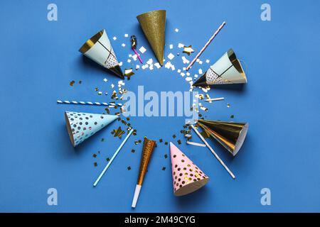 Party hats, confetti, straws and whistle on blue background Stock Photo ...