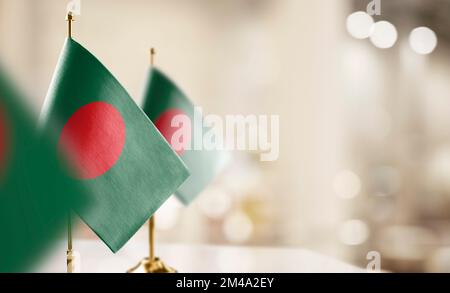 Small flags of the Bangladesh on an abstract blurry background Stock ...
