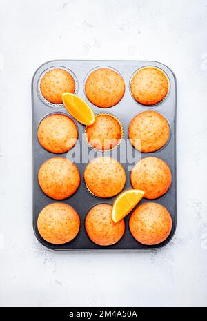 Appetizing orange muffins or cupcakes in a baking dish, winter homemade ...