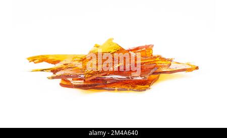 a pieces of cannabis wax closeup isolate on white background ...