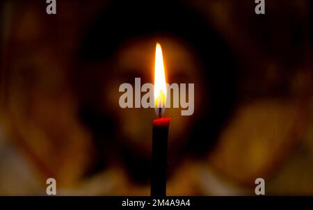 burning candle illuminates the icon of Jesus Christ Stock Photo - Alamy