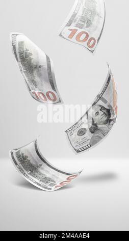 Flying dollars on gray background Stock Photo - Alamy