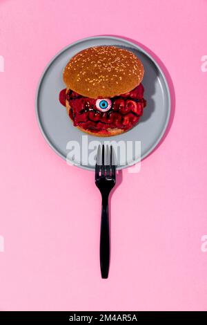 Top view of burger with bloody brain and bun with sesame seeds served ...