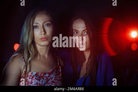 young and stylish mom with long dark hair playing with her little cute ...