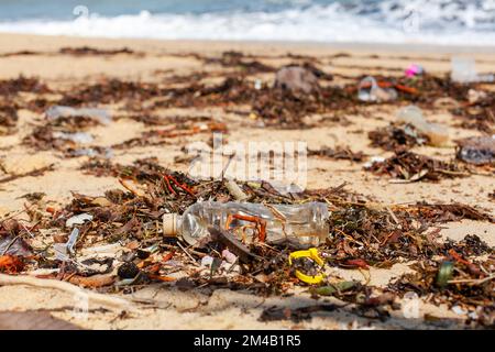 Garbage sea sand beach, unsorted rubbish, plastic bag, glass bottle ...