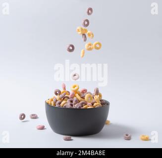 Sweet crunchy cornflakes on a gray textured background. Fast tasty ...