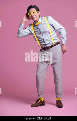 Studio shot of humorous senior Chinese man Stock Photo - Alamy