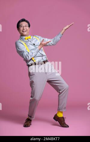 Studio shot of humorous senior Chinese man Stock Photo - Alamy