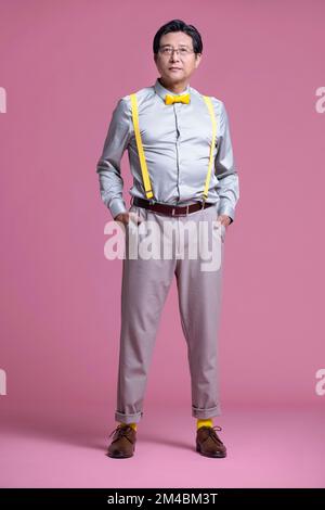 Studio shot of humorous senior Chinese man Stock Photo - Alamy