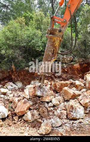 excavator crusher machine breaks rocks to widen road Stock Photo - Alamy