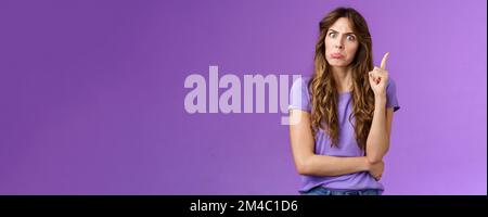 Strict funny curly-haired girl pulling disappointed angry face popping ...