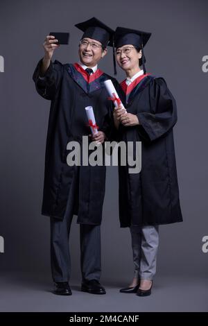 Senior Chinese students cheering for graduation Stock Photo - Alamy