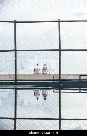 Silhouette of a sport court wet from the rain against dramatic sunset ...