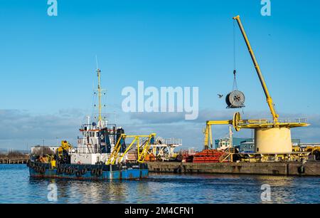 Forth Sentinel utility ship dredging Leith Harbour with industrial ...