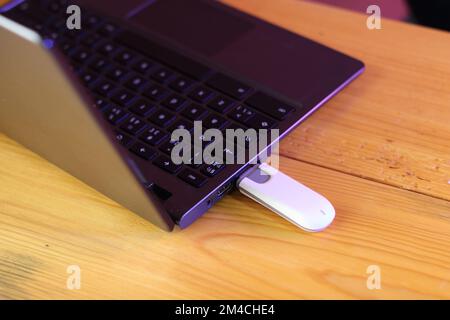 laptop with connected gsm modem on table and pink background Stock ...