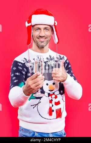 man hold champagne for xmas show thumb up in studio. xmas champagne and ...