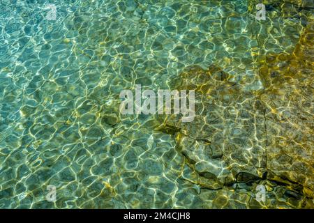 Sunlit water, rocks along the Lake Huron shoreline, Bruce Peninsula ...