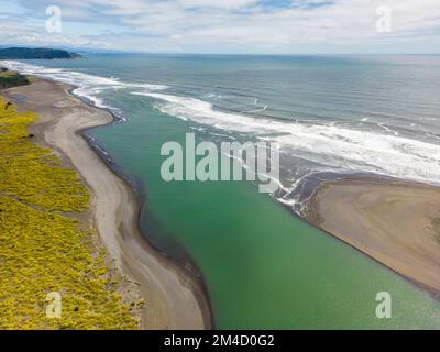 Aerial shot of the point where the river Tolten flows into the pacific ...