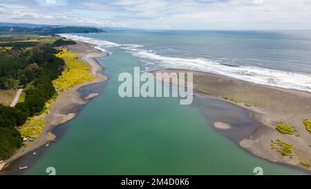 Aerial shot of the point where the river Tolten flows into the pacific ...
