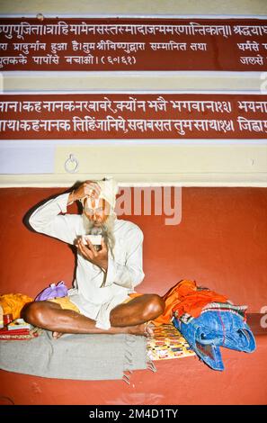 Rama-Sadhu painting a fresh tilak on his forehead on the ghats of ...