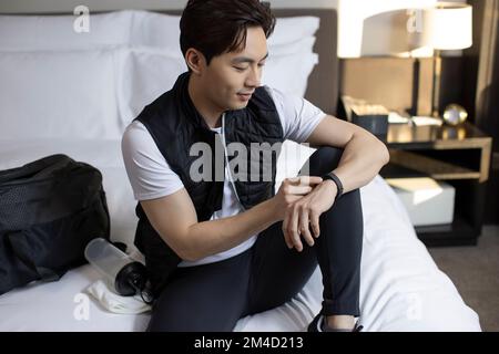 Chinese mid adult man getting ready to go out and workout Stock Photo ...