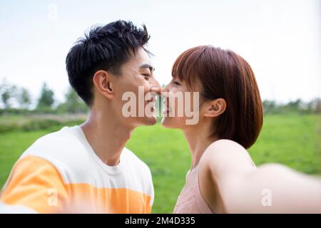 Happy young Chinese couple kissing in bedroom Stock Photo - Alamy