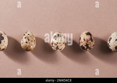 A line with shadows from quail eggs on beige minimal background Stock ...