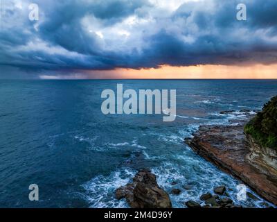 Aerial rainy day sunrise over the ocean at Avoca Beach on the Central ...